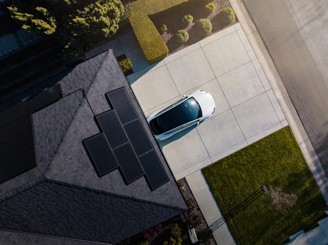 Overhead view of solar panels and Tesla car.